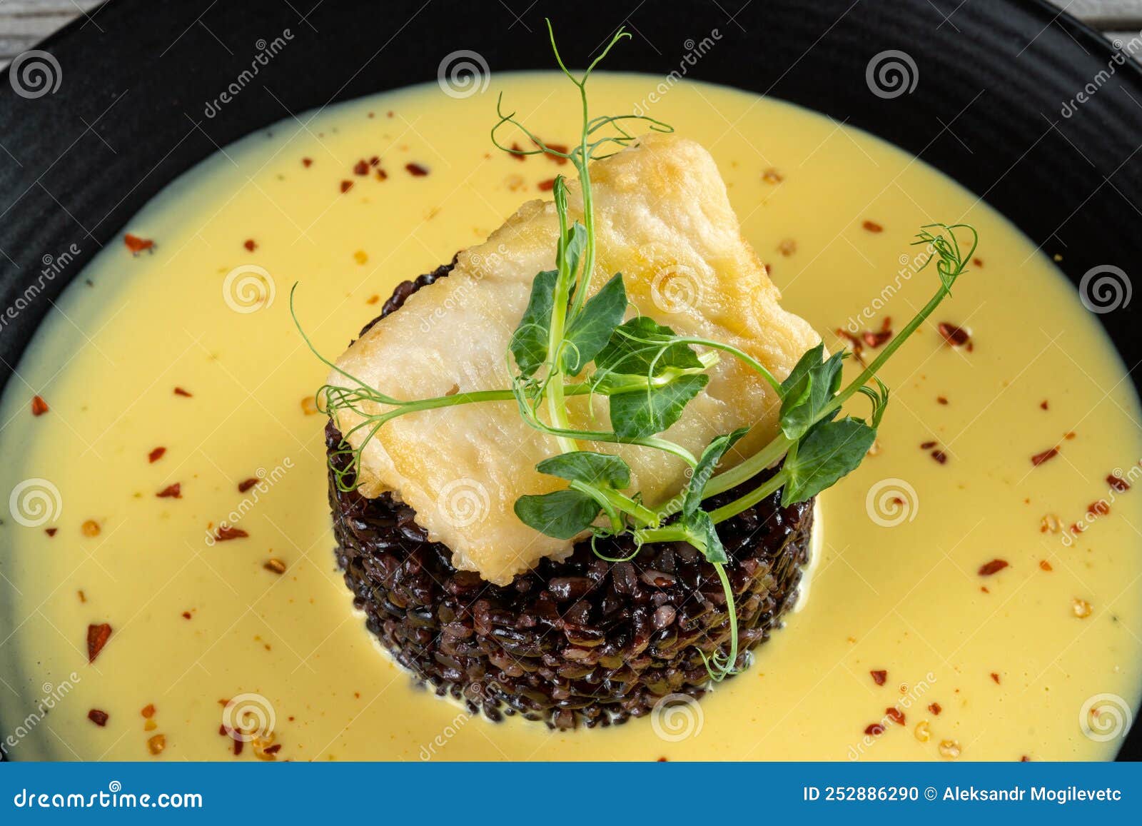 Risotto with Slice Roasted White Fish, Cod on Black Background. Grilled ...