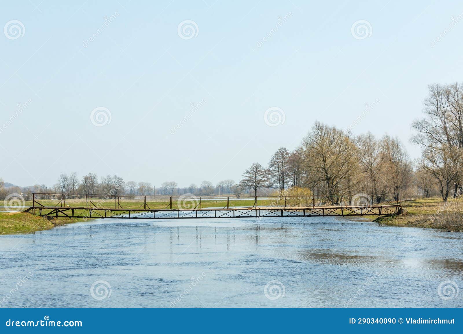 River Bank in Spring. a Small Pedestrian Bridge Across the River Stock ...