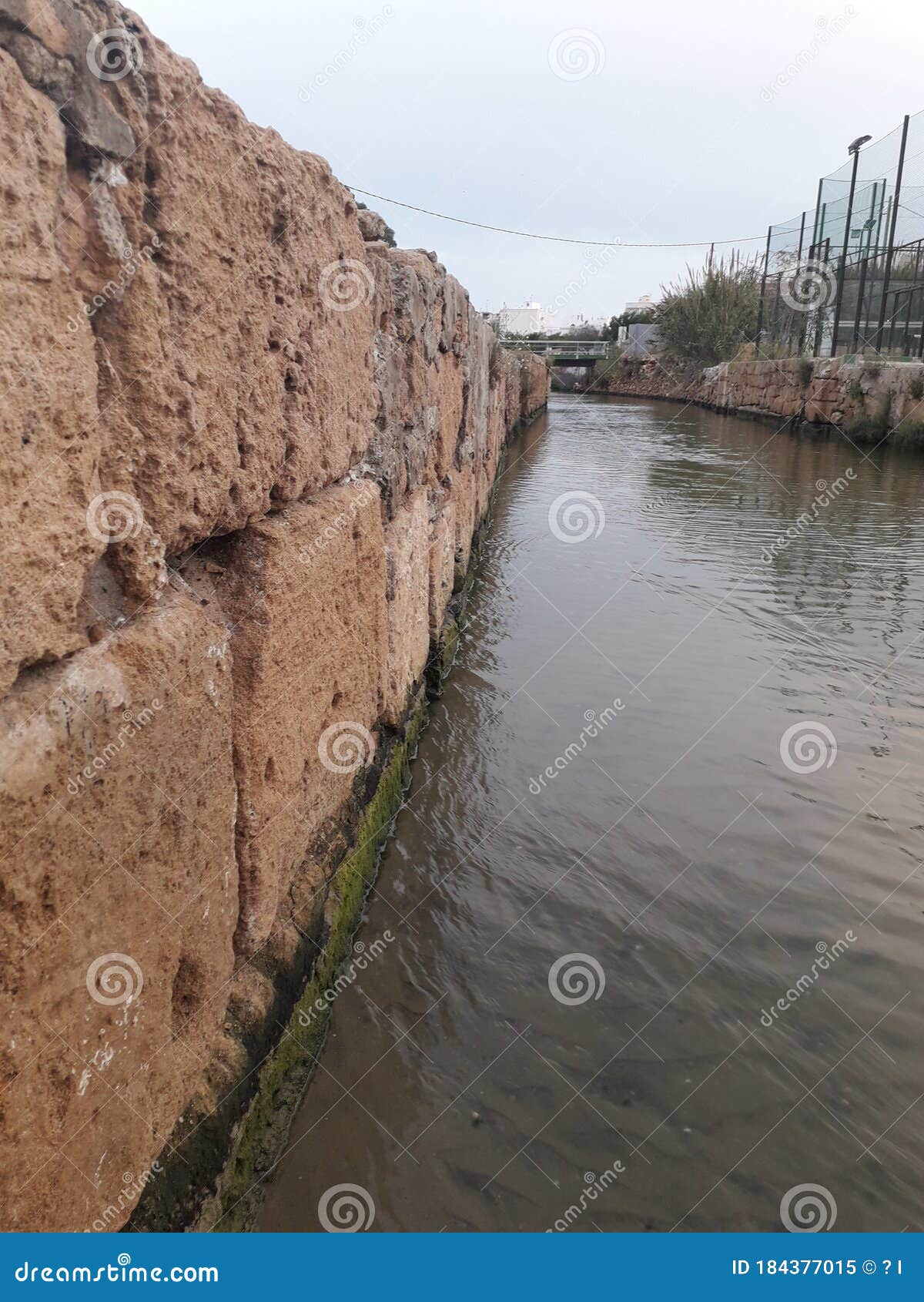 A river bounded by walls stock image. Image of rock - 184377015