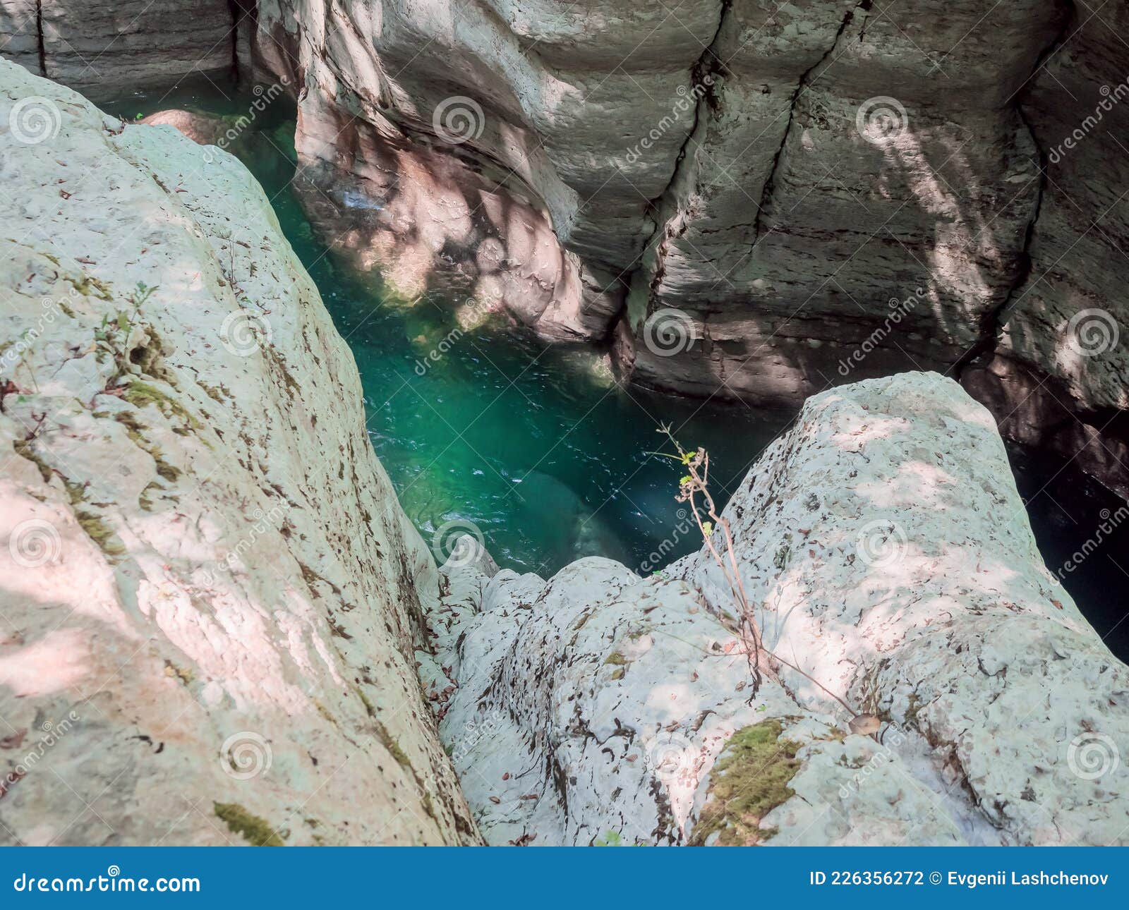 A River with Bright Transparent Turquoise Water Flows into a Gorge ...