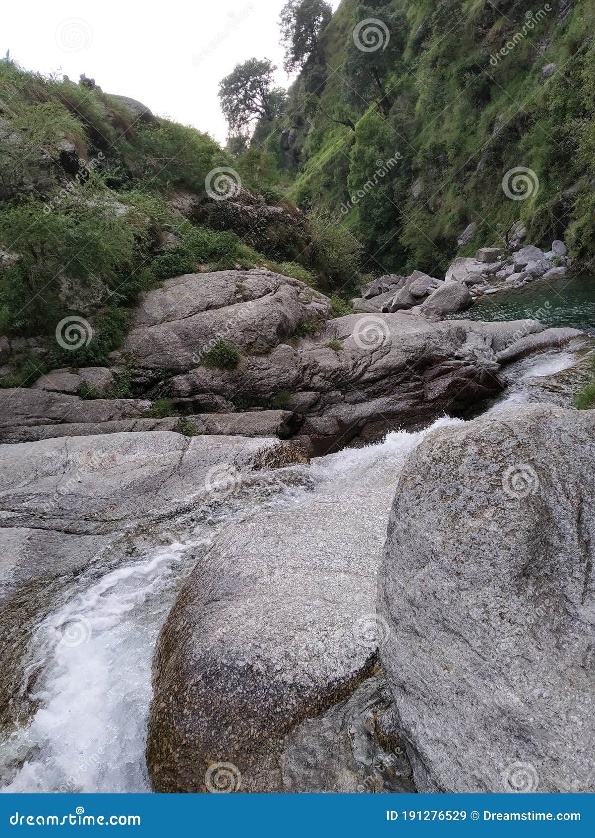 A River Falling through Rocks in between Mountains Stock Image - Image ...