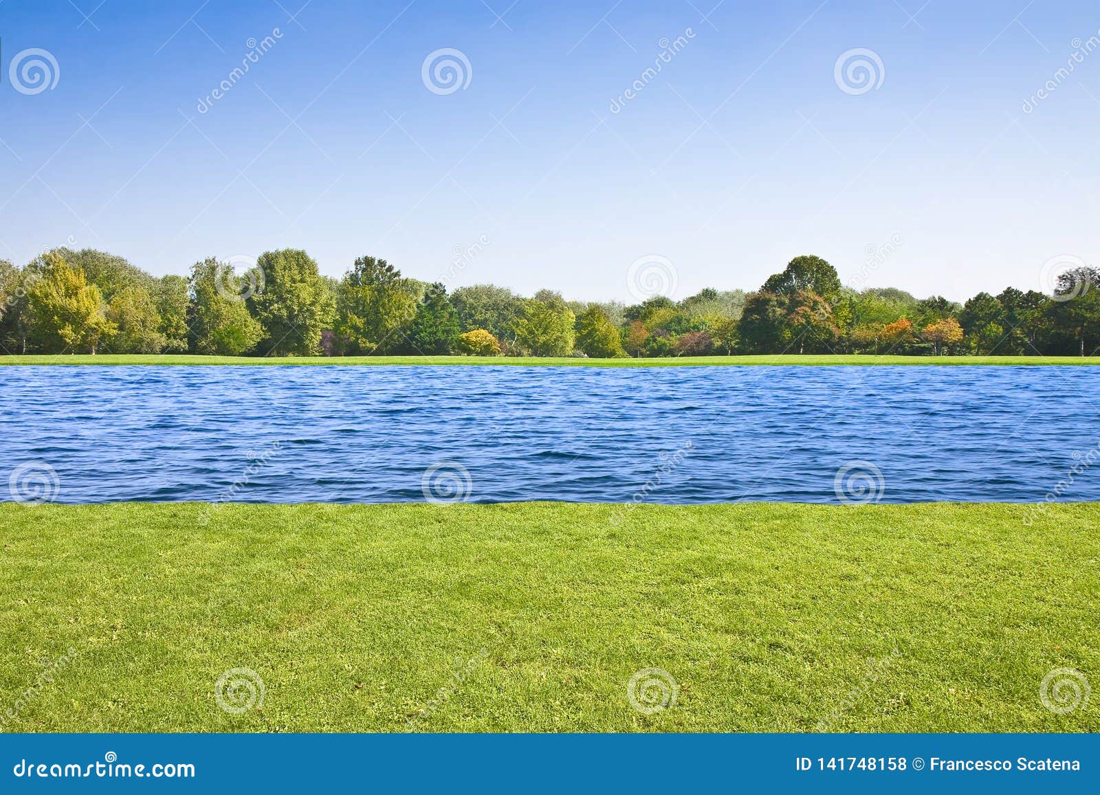 A River Flows Quietly on a Flat Land with Mowed Lawn and Trees Stock ...
