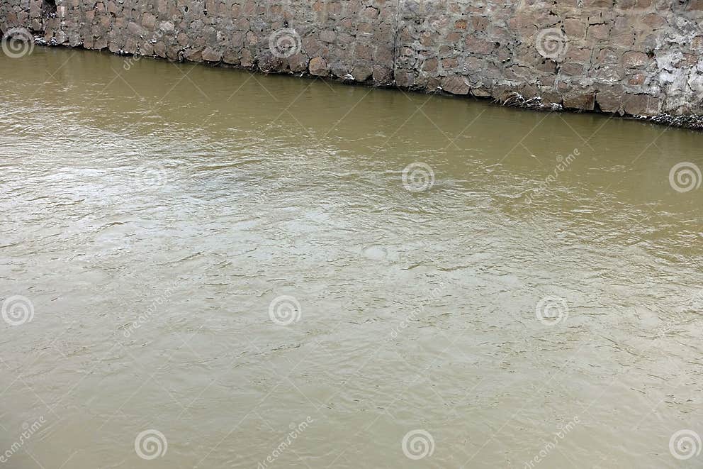 A River with Murky Waters, a River Flowing through a Settlement Stock ...
