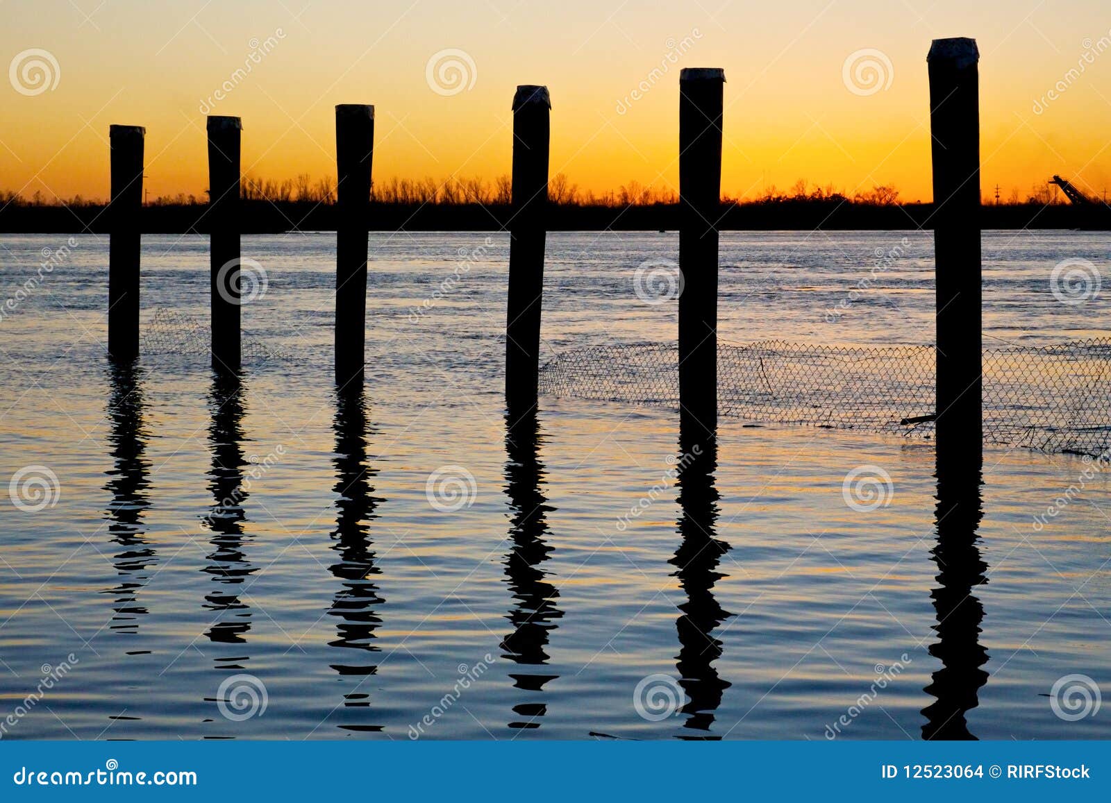 River Posts at Sunset stock photo. Image of shadow, posts - 12523064