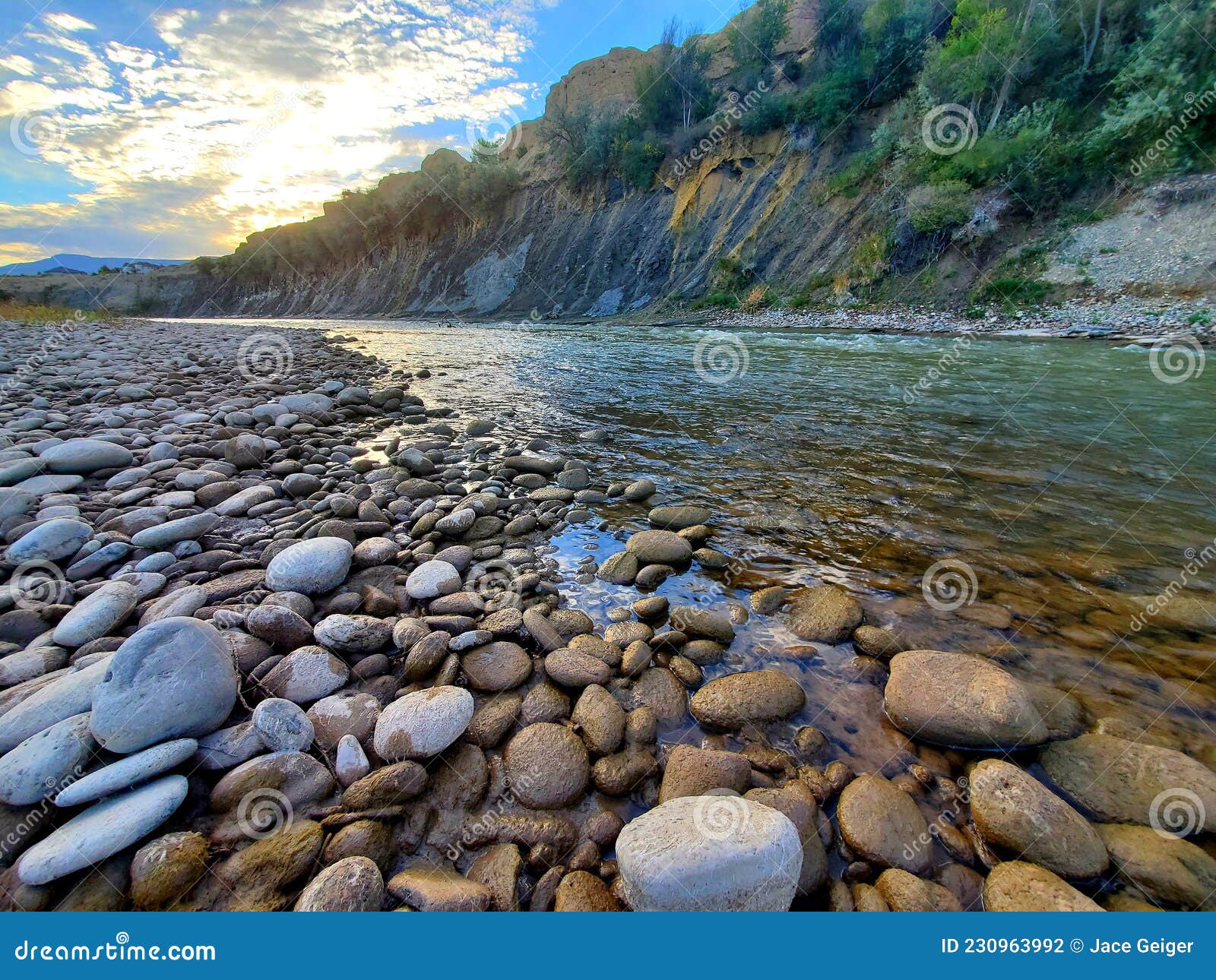 River rock sunset stock photo. Image of wave, beach - 230963992