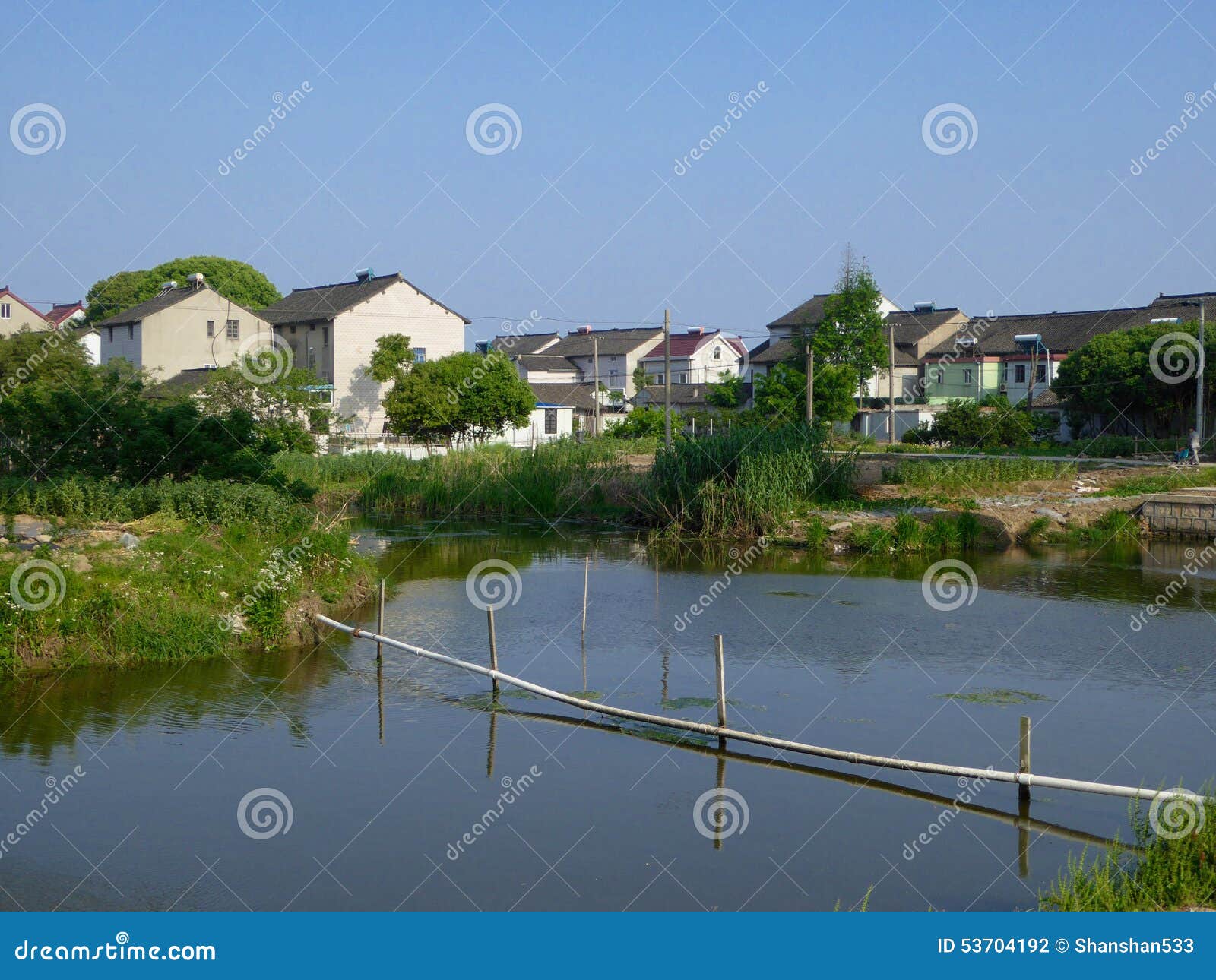 A River through a Small Village Stock Photo - Image of green, pond ...