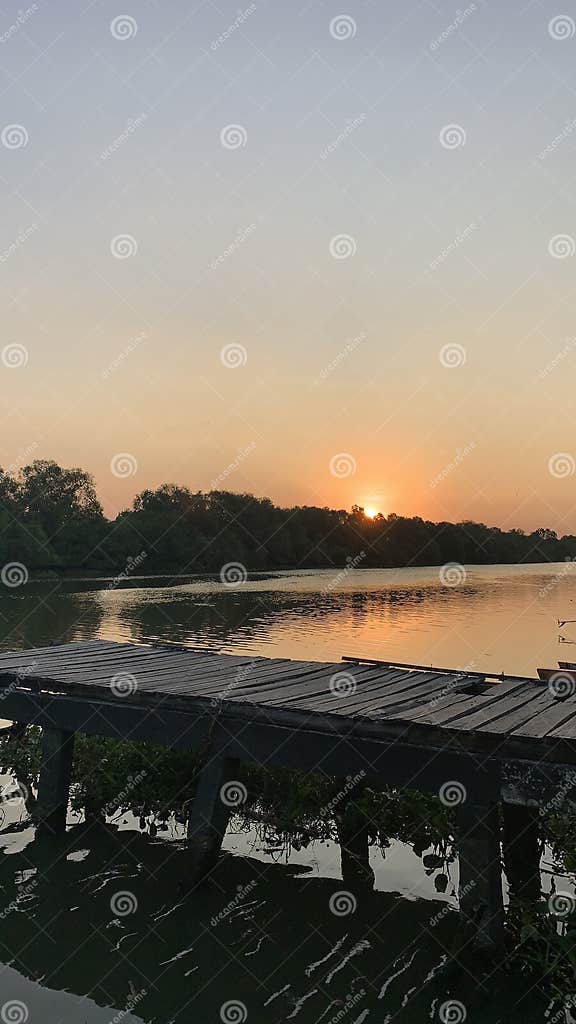 River when the Sun is almost Setting Stock Photo - Image of orange ...
