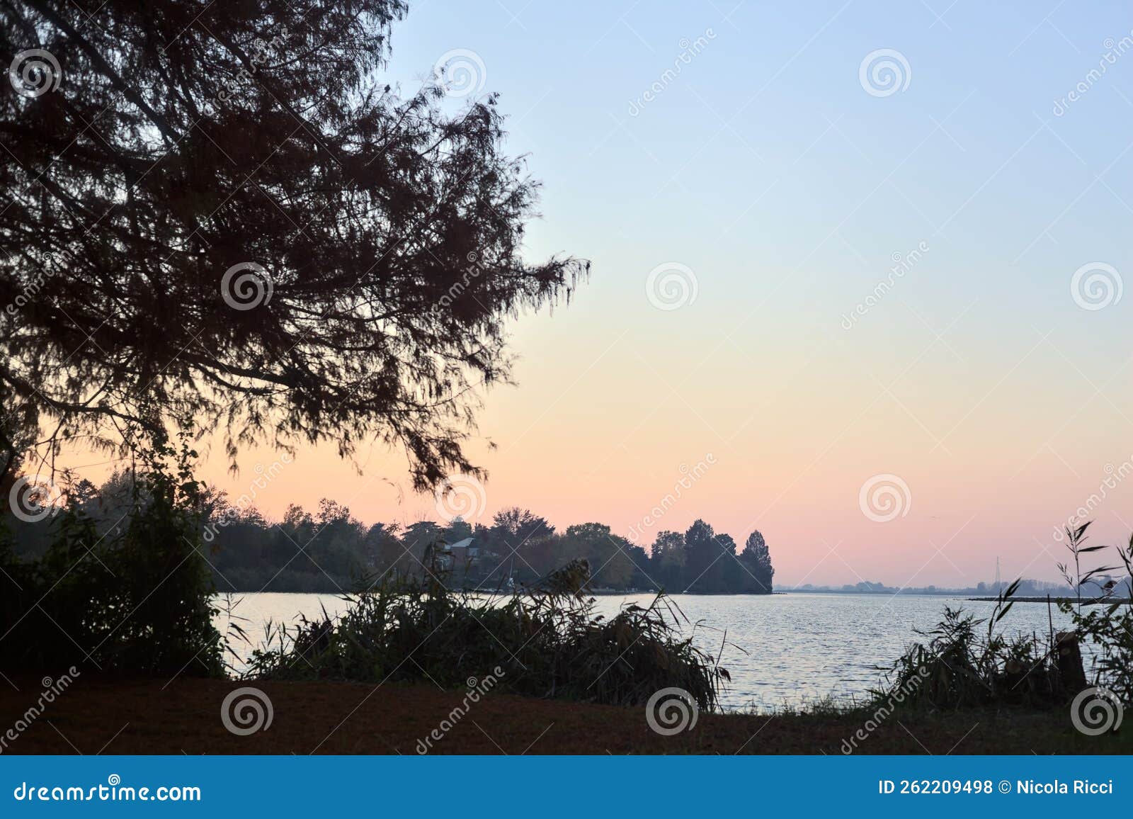 River at Sunset with a Shore that Stretches on the Horizon Framed by a ...