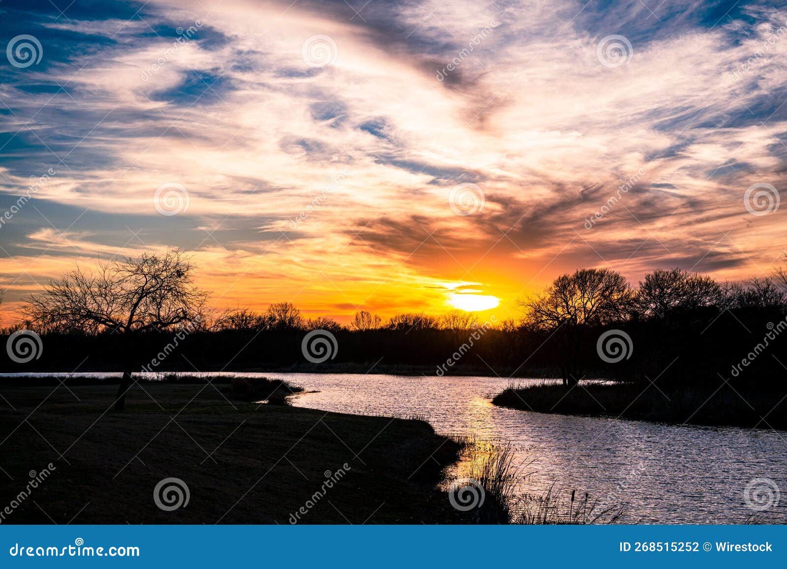 River and Trees on the Shore in Shadow with a Beautiful Sunset in the ...