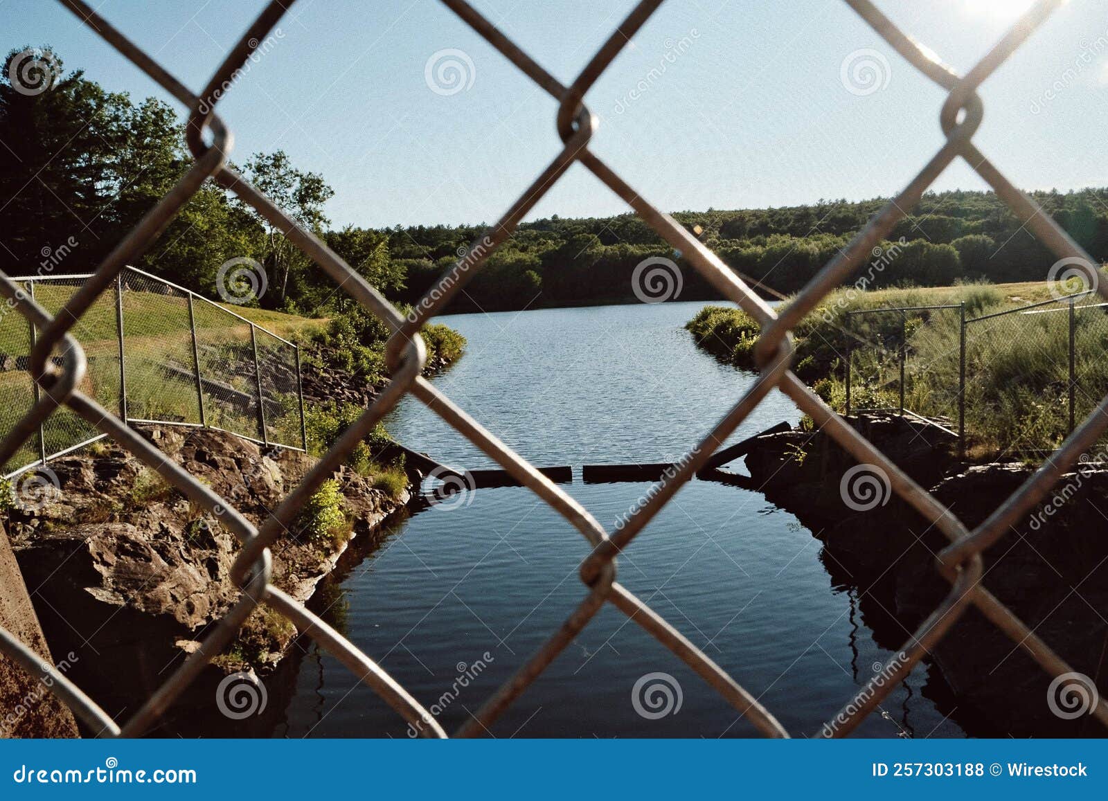 River View through a Metallic Net with a Bridge and a Shining Sun in ...