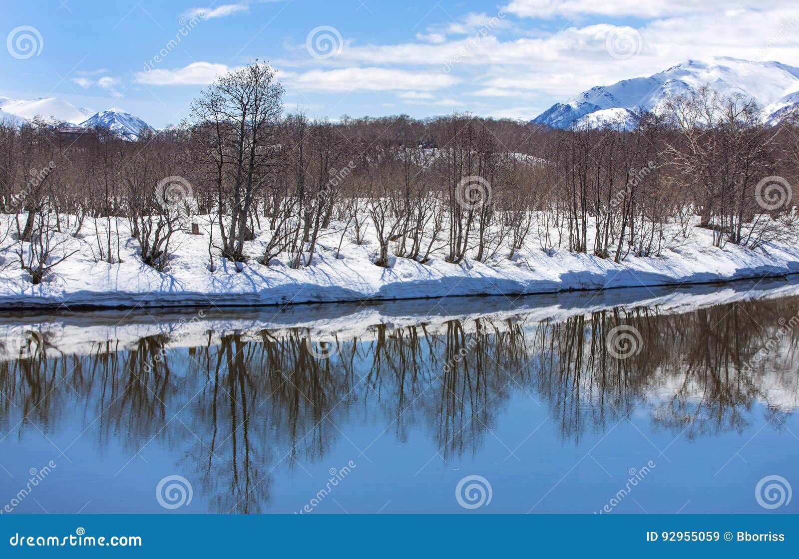 A Volcano With A Snow-capped Peak On The Background Of A Blue Sky With ...