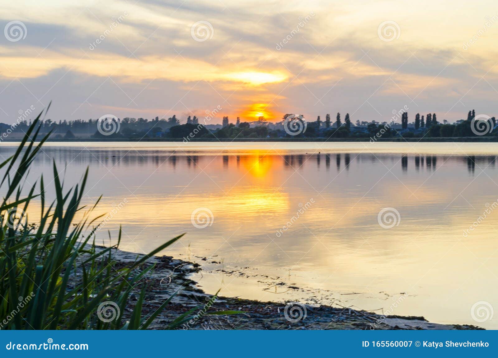 Riverbank at sunset stock image. Image of colorful, scenic - 165560007