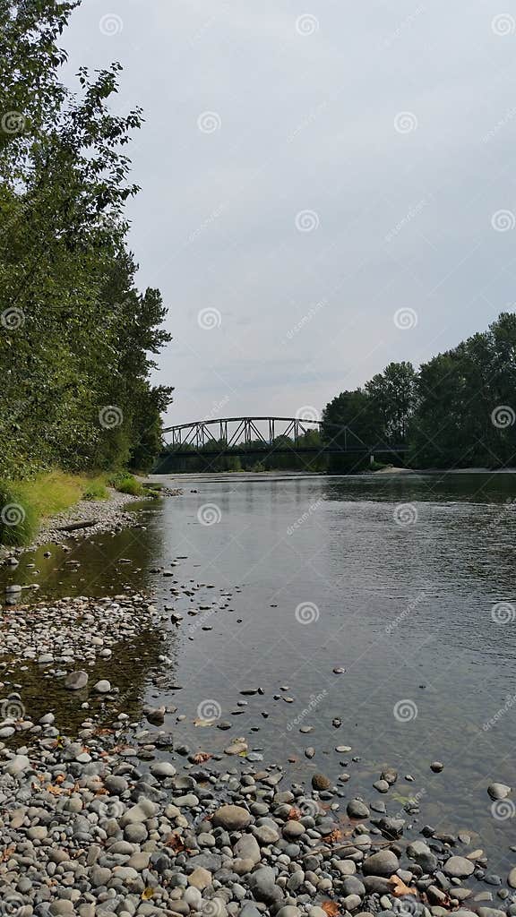 Riverside stock image. Image of riverside, rocks, bridge - 57886505