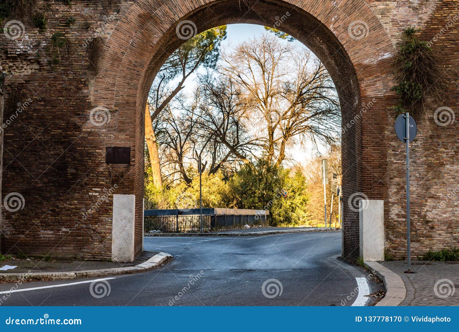Road through arch stock photo. Image of green, fence - 137778170