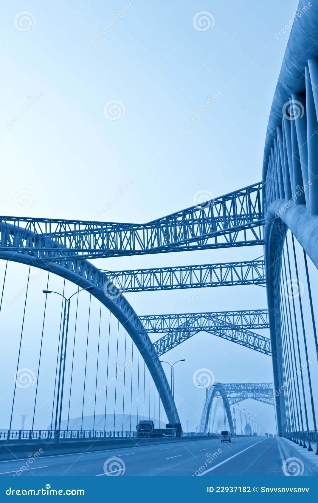 Road through the Bridge of a City Stock Photo - Image of arch, metal ...