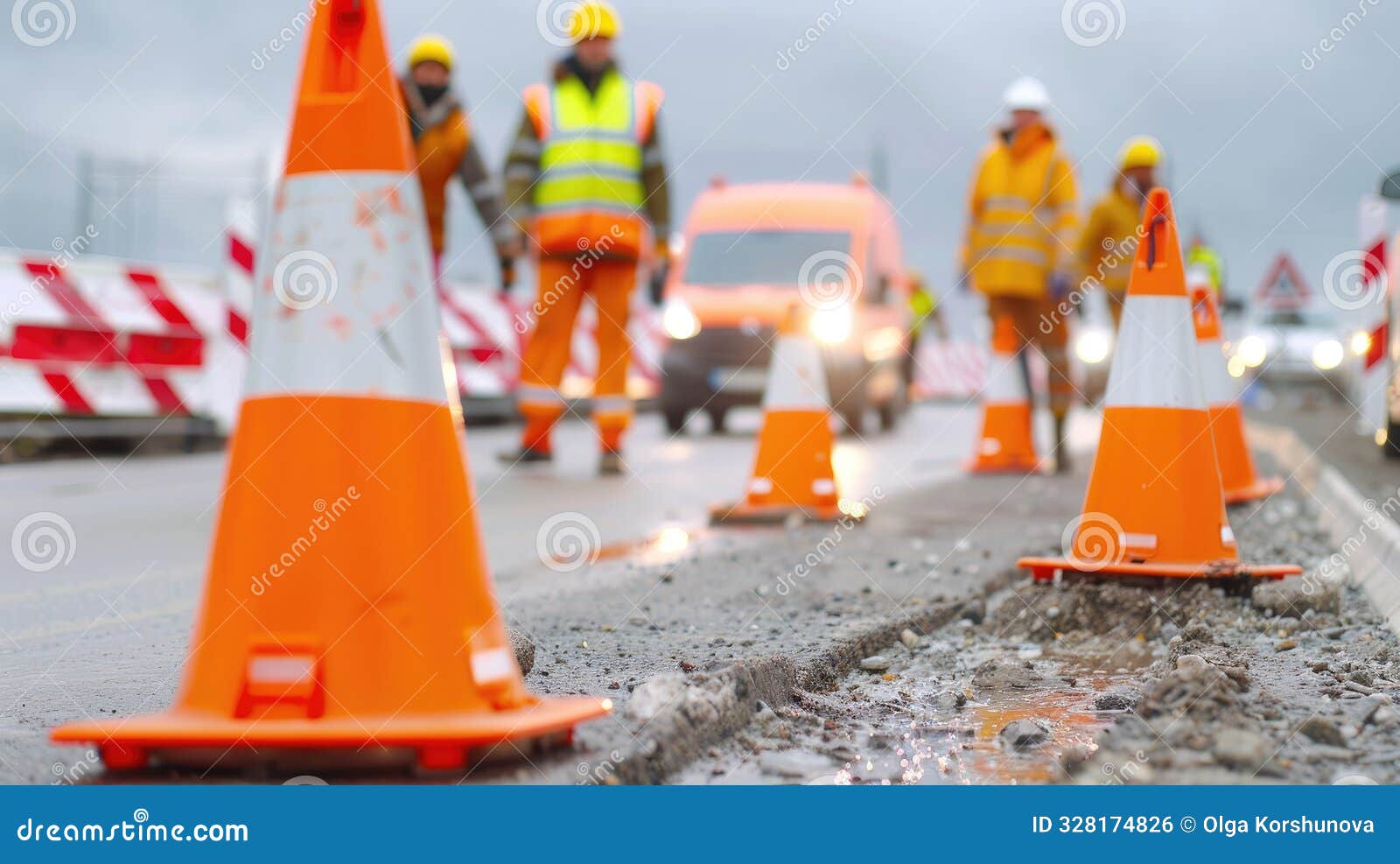 Road Construction Crew Working Behind Traffic Cones at Dusk Stock Photo ...