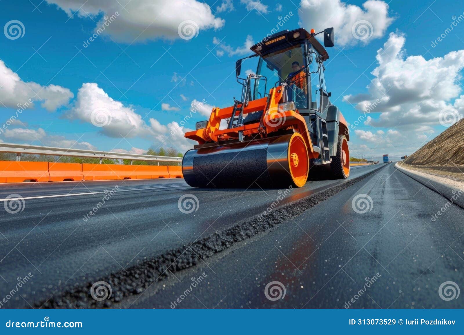 Road Construction Equipment is Working on the Asphalt Road Surface ...