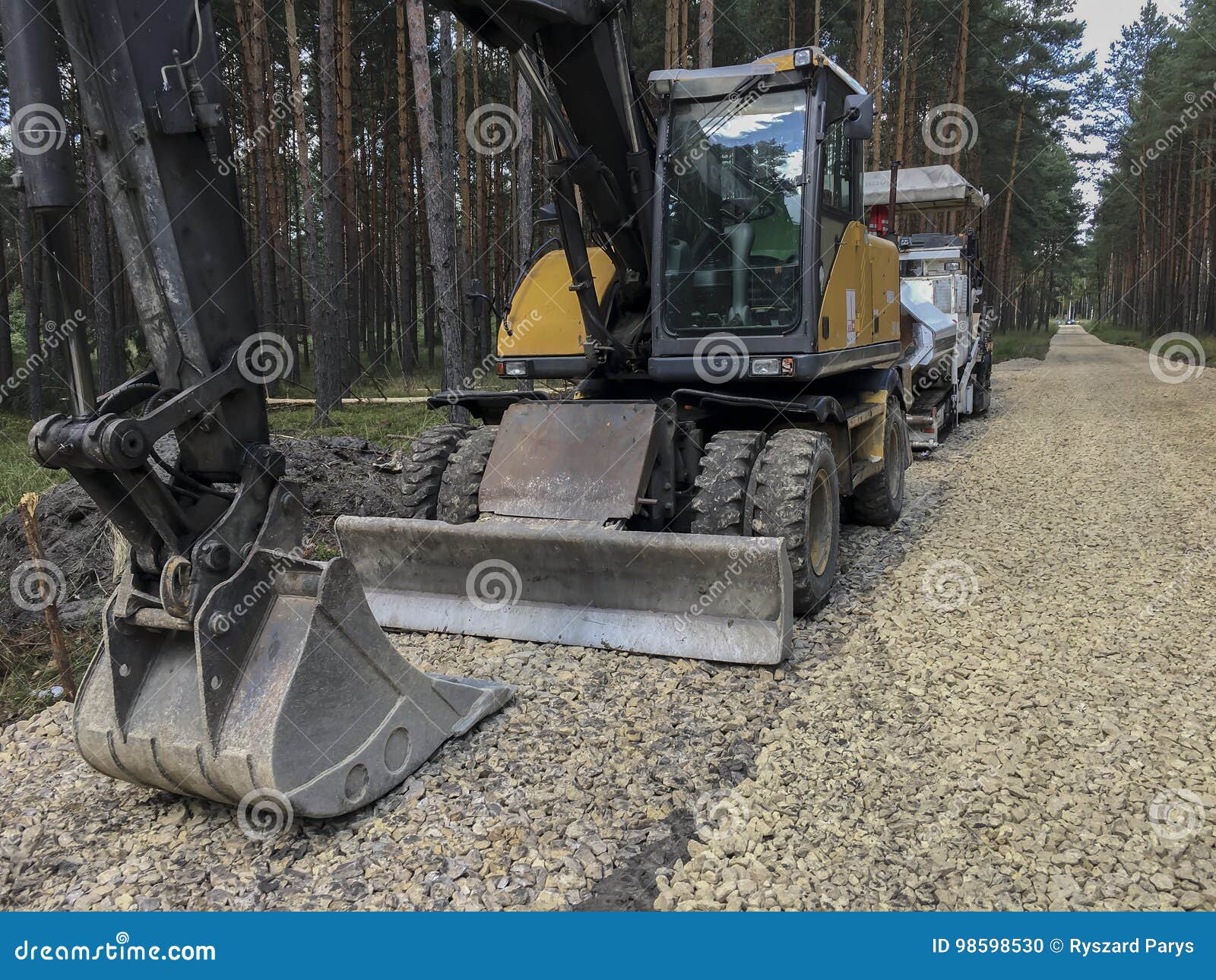 Road construction machine stock photo. Image of forest - 98598530