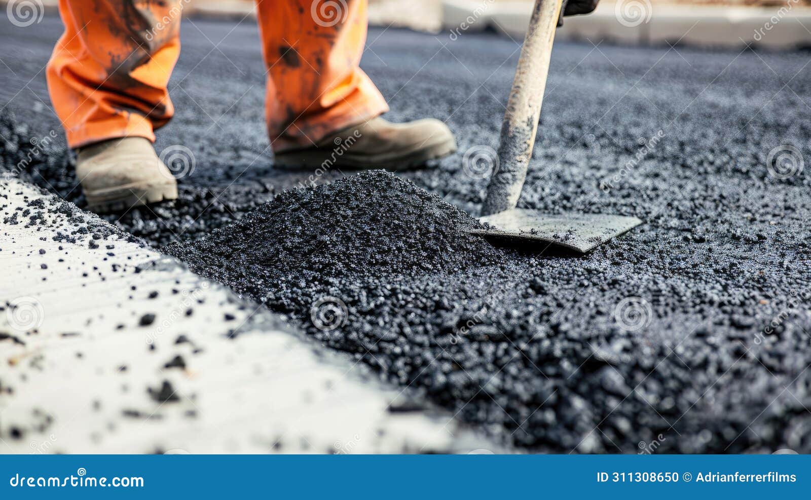Road Construction Worker Leveling Asphalt with a Shovel. Stock Photo ...