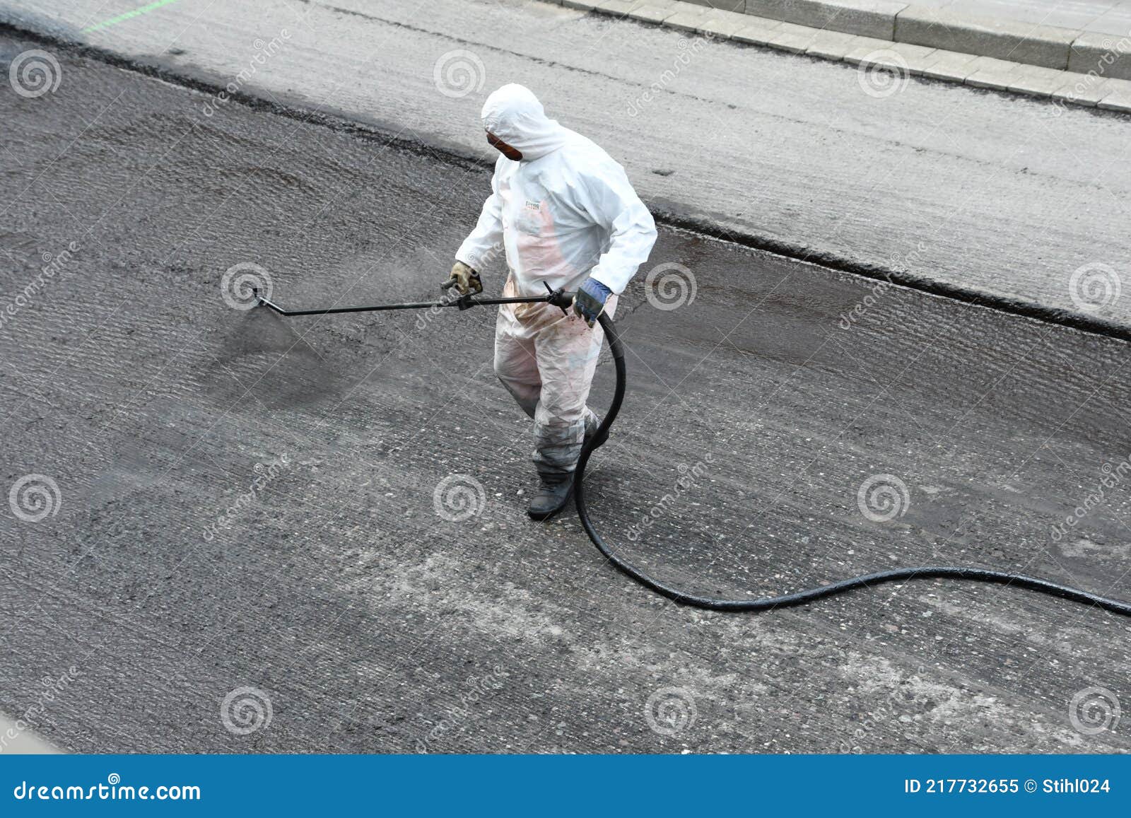 Road Construction Worker Working Spraying Liquid Bitumen on Road ...