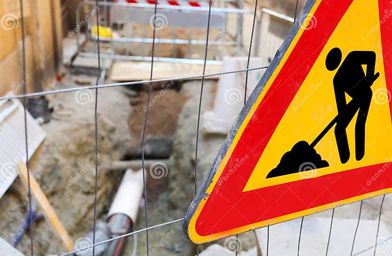 Road Excavation and the Caution Work in Progress Sign Stock Photo ...