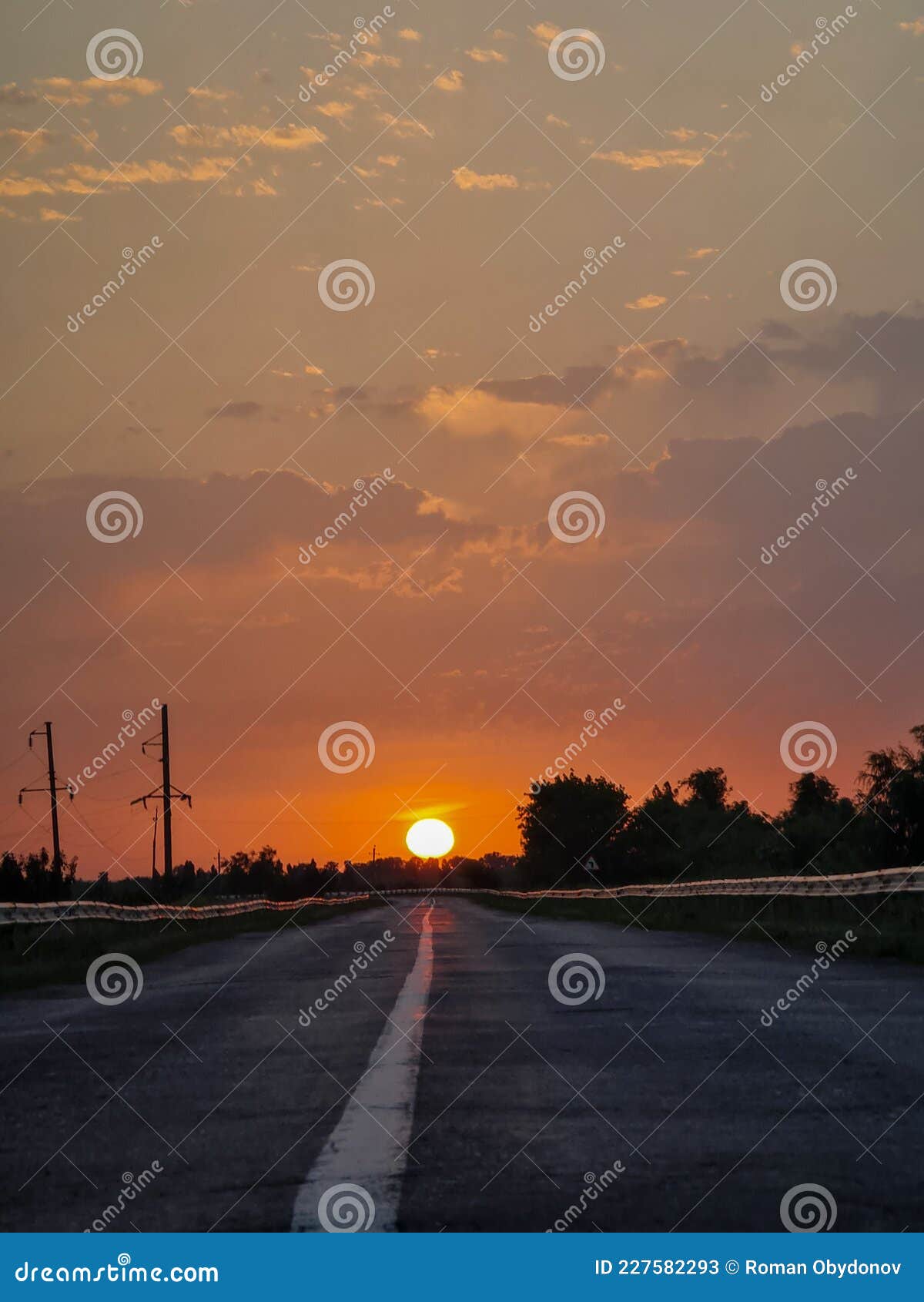 The Road Going into the Distance Against the Backdrop of the Sunset ...