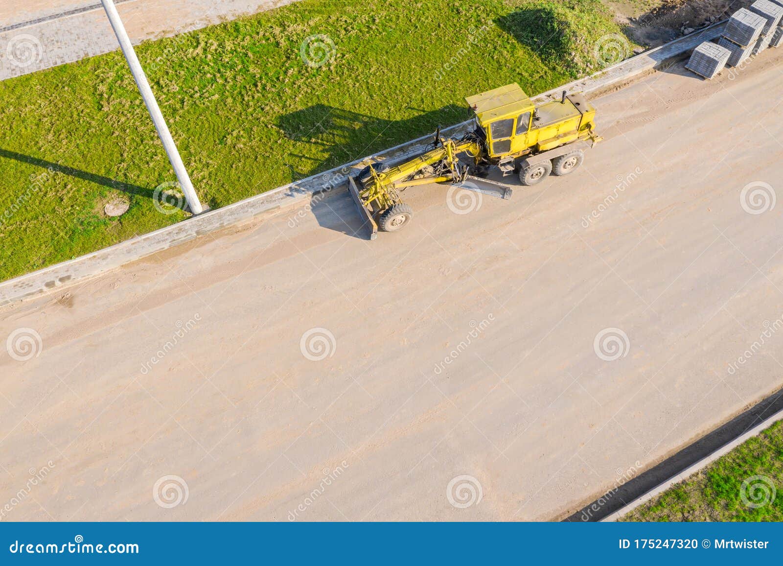 Road Grader Standing at Road Construction Site. Aerial View Stock Photo ...