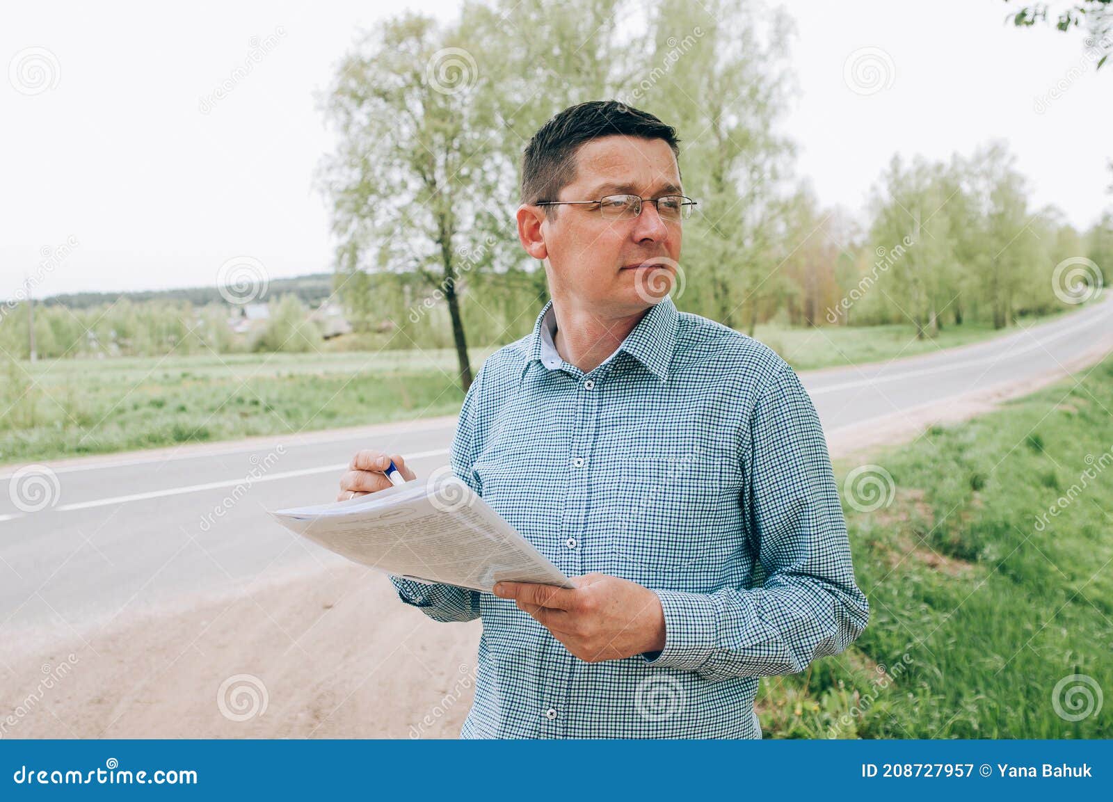 The Road Inspector on a Working Platform. Stacking of New Asphalt Stock ...
