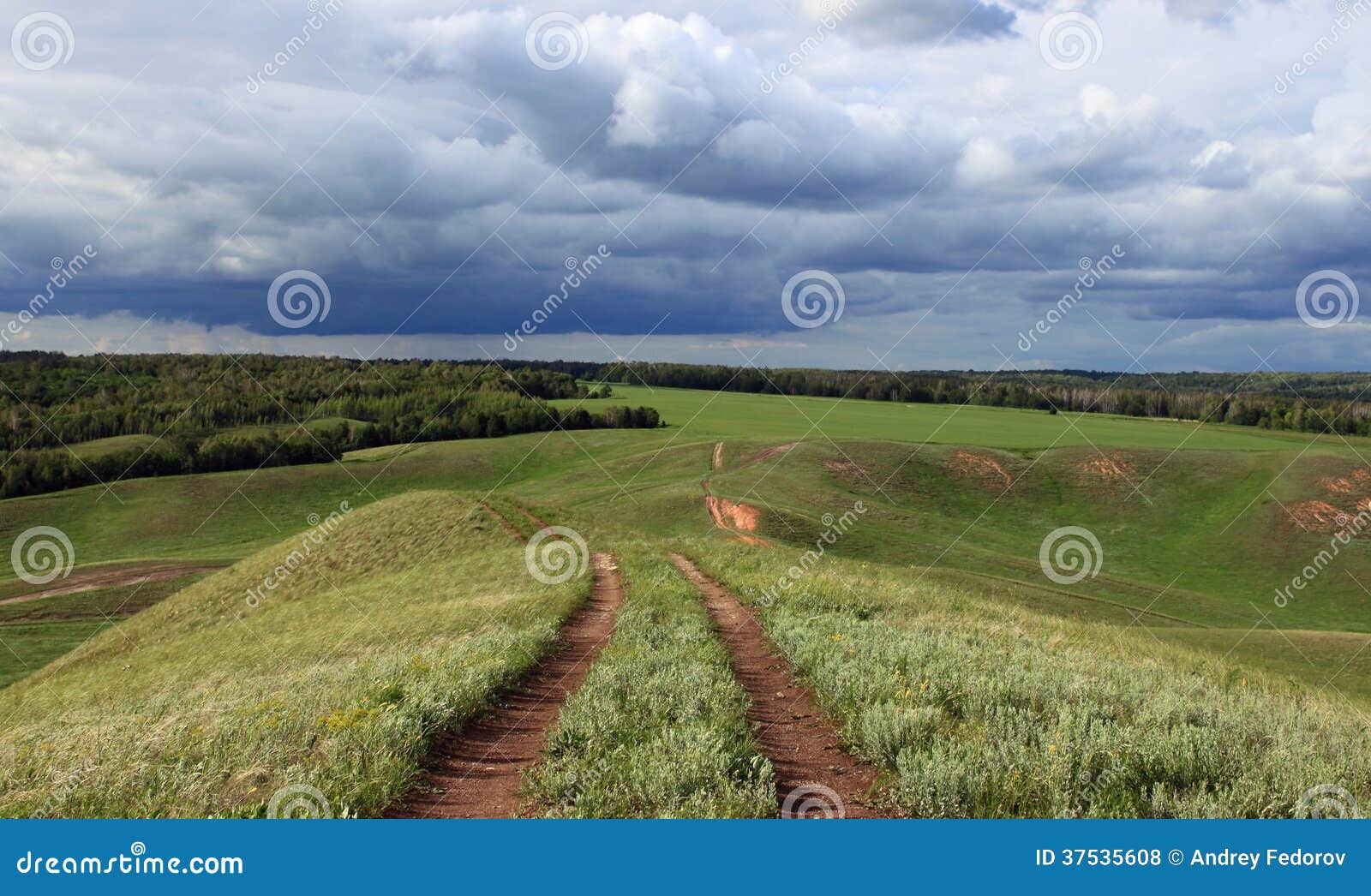 The Road Leading Down from the Hill Stock Photo - Image of clouds, road ...
