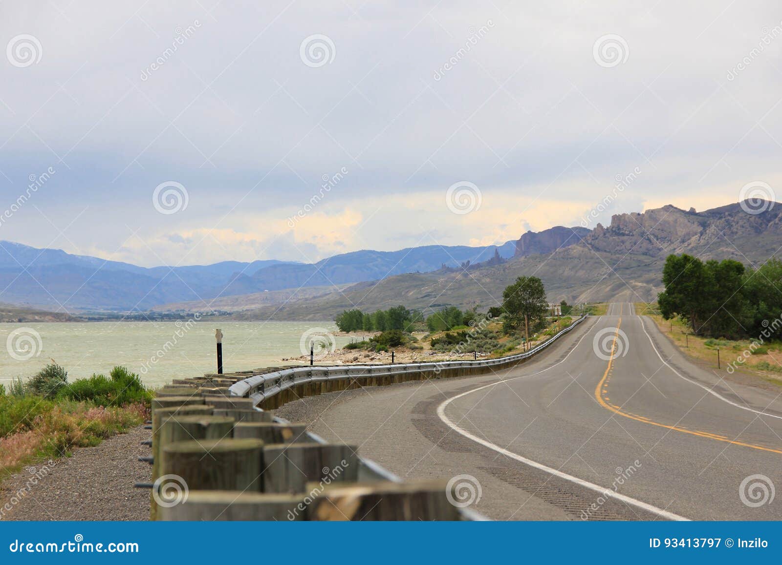 Road next to a lake stock image. Image of highway, clouds - 93413797