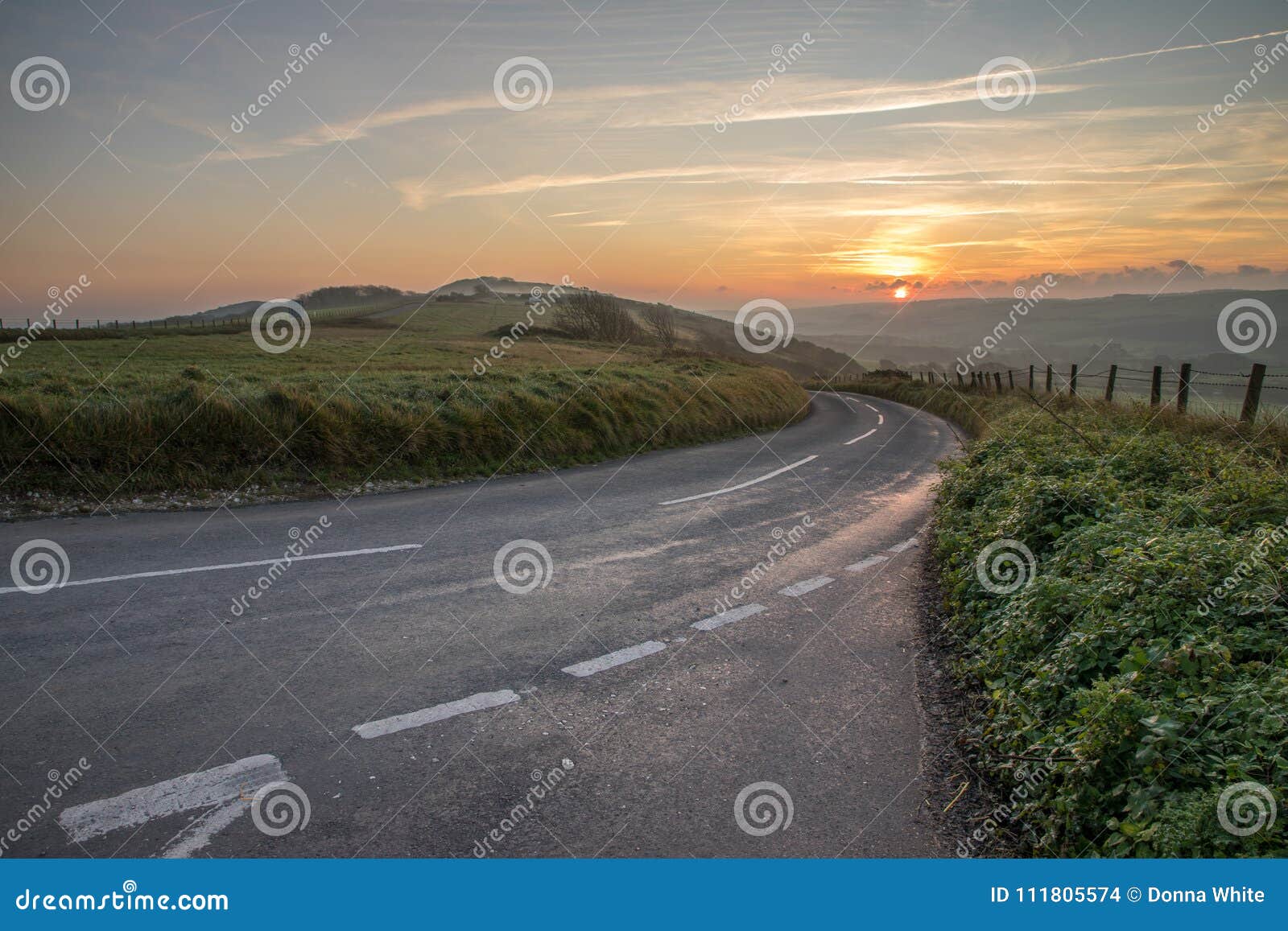 Road over hills at sunrise stock photo. Image of lane - 111805574