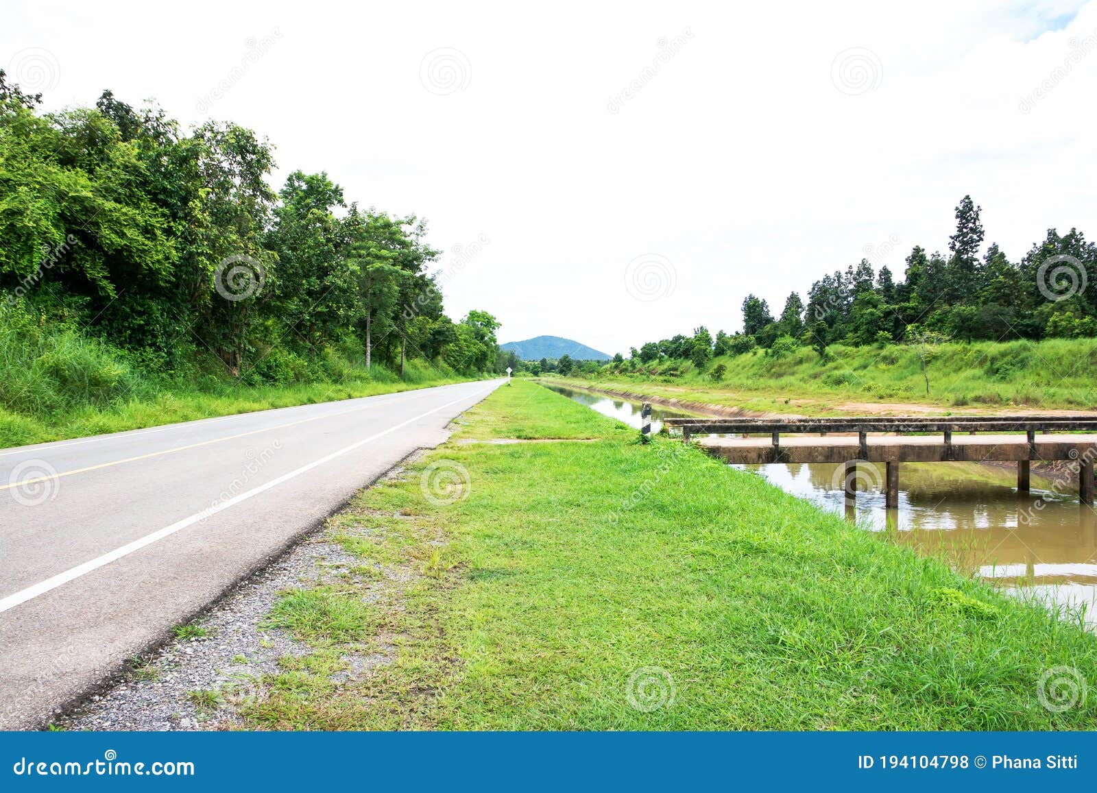 Scenery View of the Road beside the River and Concrete Bridge at Rural ...