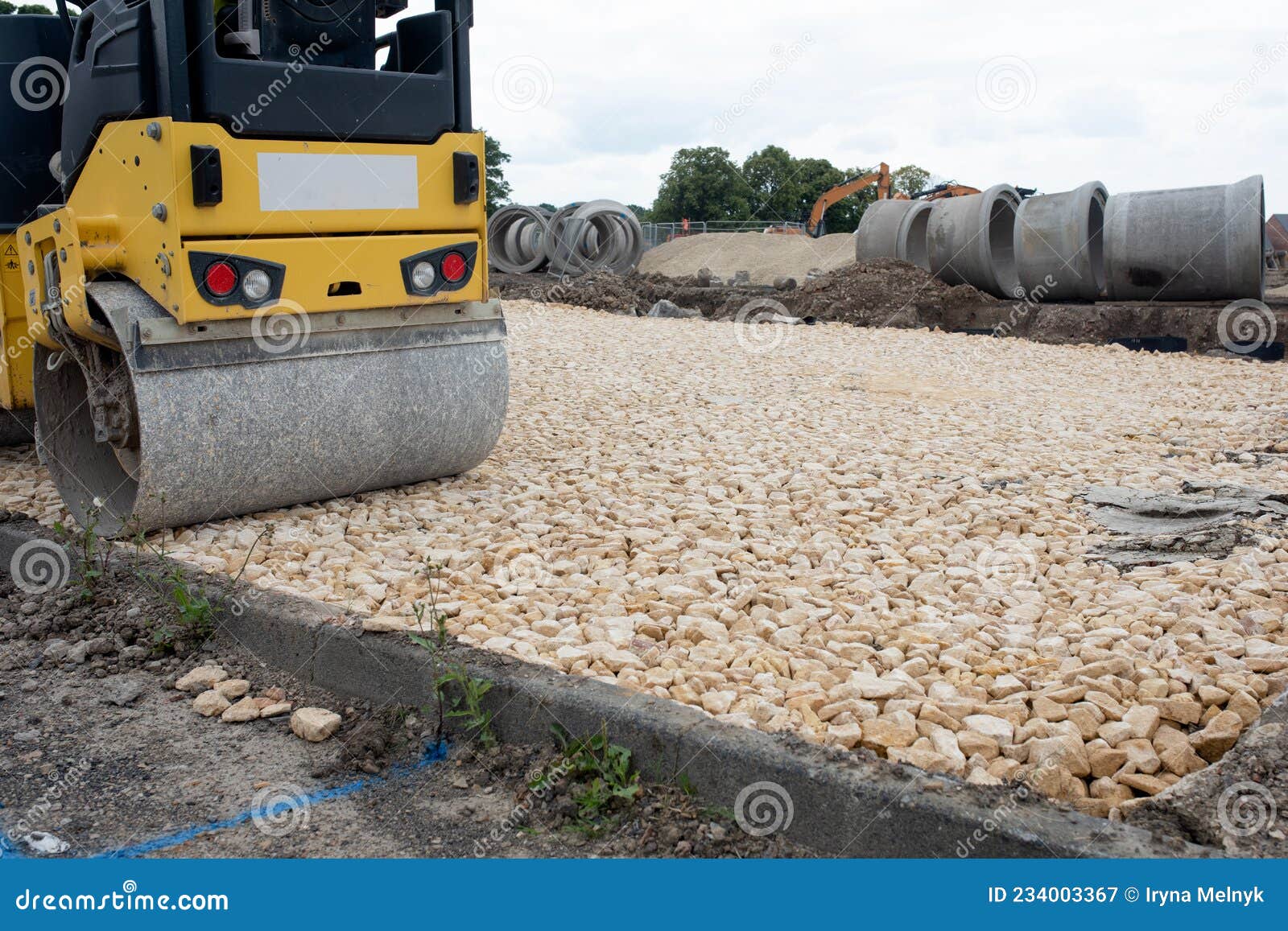 Road Roller Compacting Stone during New Road Construction in ...