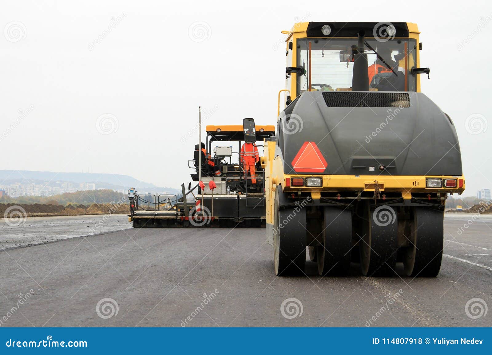 Road Roller Machine and Pavement Spreader Machine Works Stock Photo ...