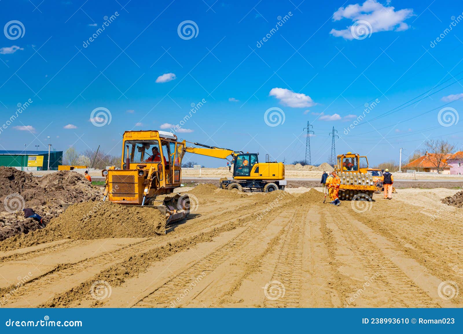 Road Roller with Spikes and Earthmover are Working at Construction Site ...