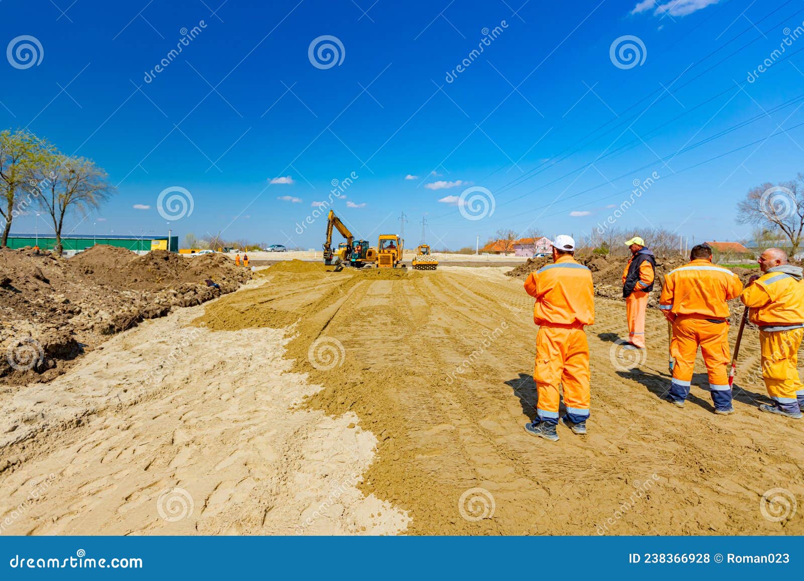 Road Roller with Spikes and Earthmovers are Working at Construction ...