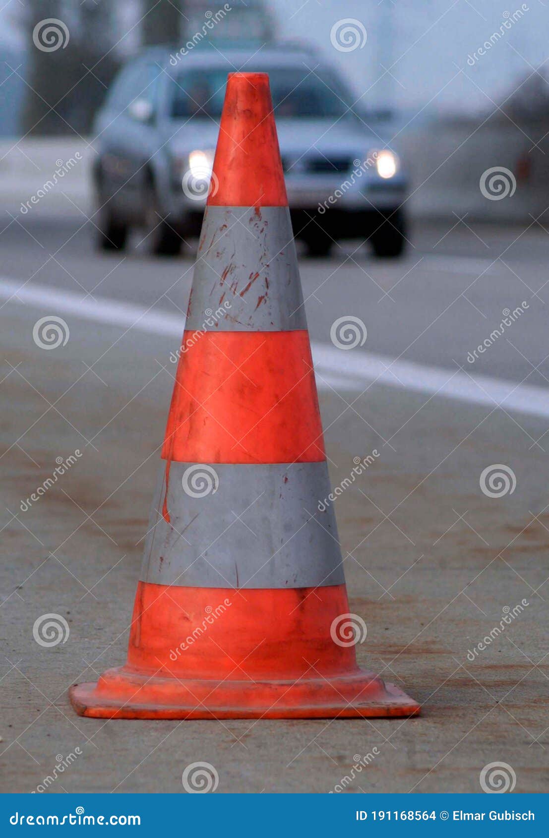 Traffic Cone in Front and Car Headlights in the Back Stock Photo ...