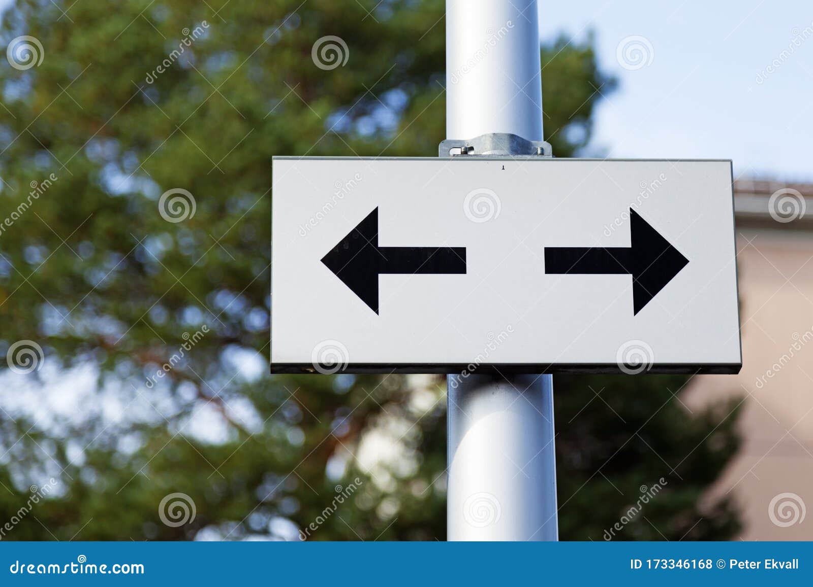 Road Sign with Arrows in Two Different Directions Stock Photo - Image ...