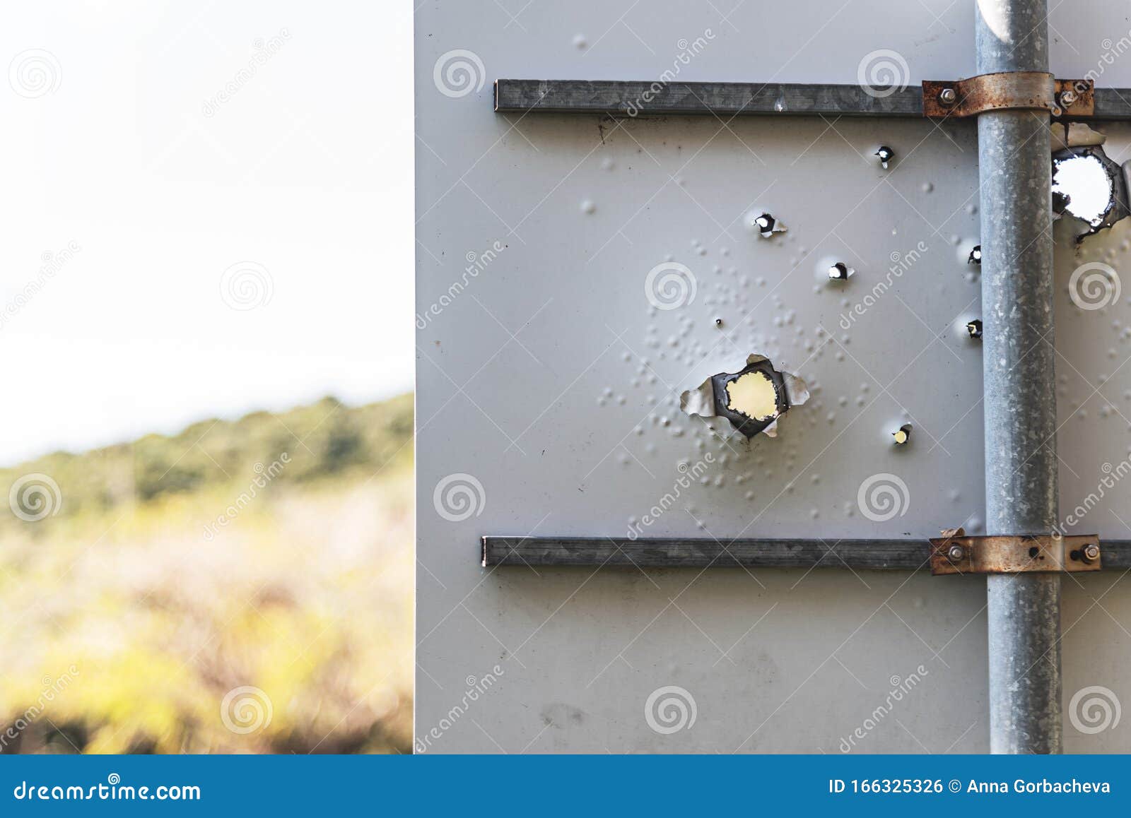 Road Sign with Bullet Holes Stock Photo - Image of holes, shot: 166325326