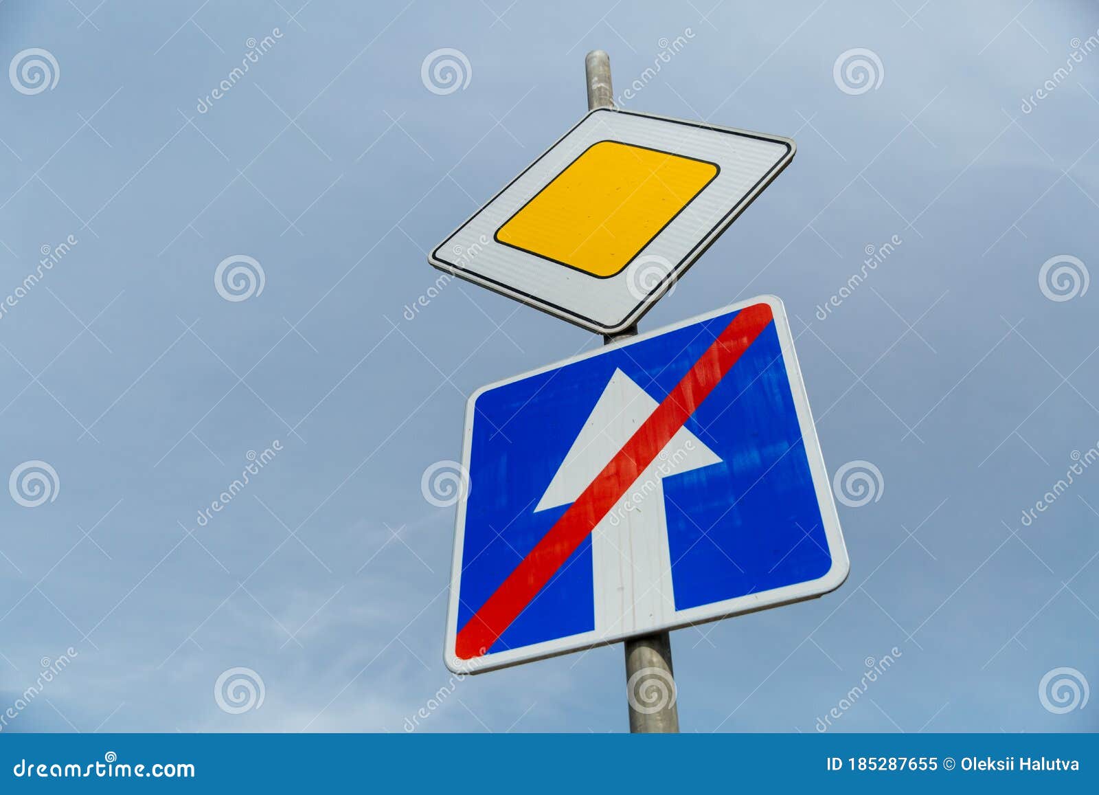 Road Sign Main Road and One-way Road End Sign on Blue Sky Background ...