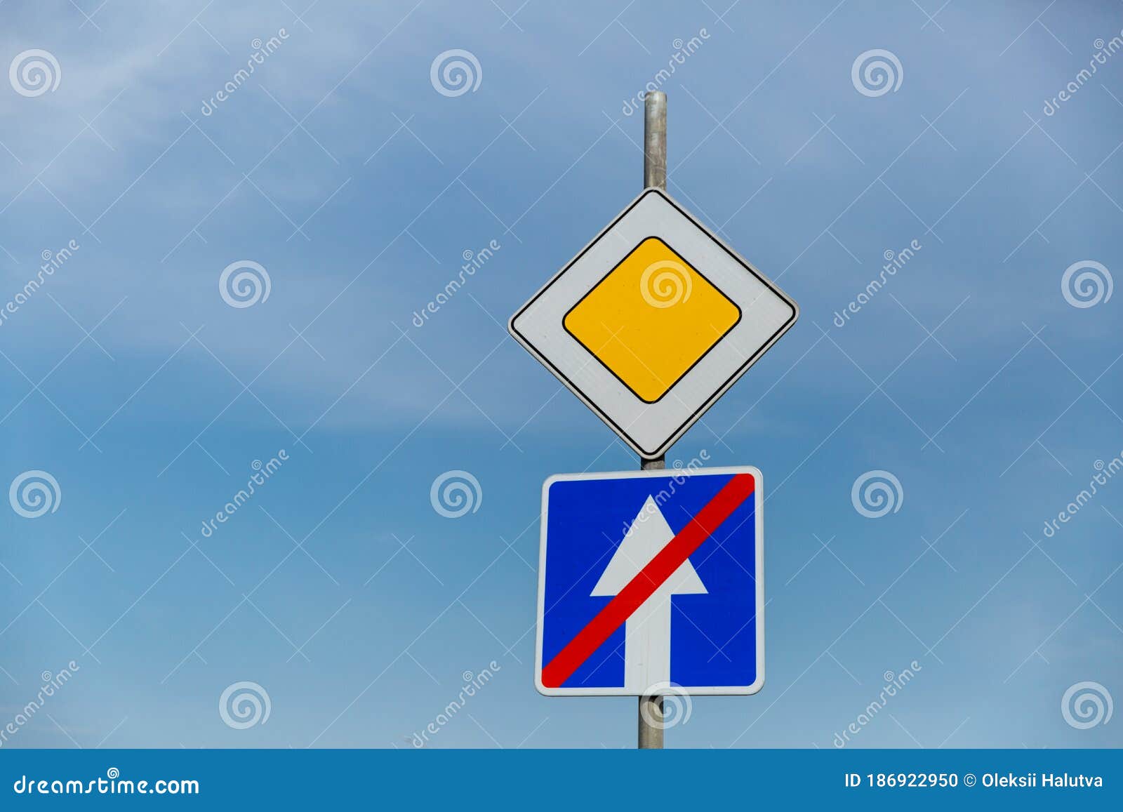 Road Sign Main Road and One-way Road End Sign on Blue Sky Background ...