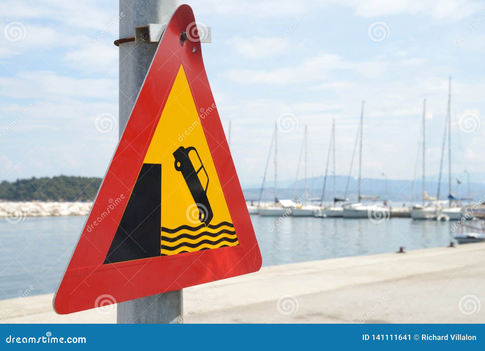 Road Sign Indicating a Risk of Falling into the Water with a Car Stock ...