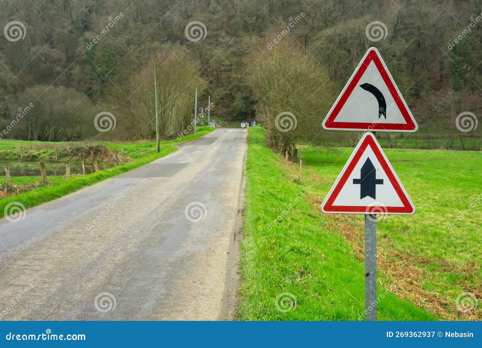 Road and Road Sign Warning about a Turn in the Road. Road Safety ...