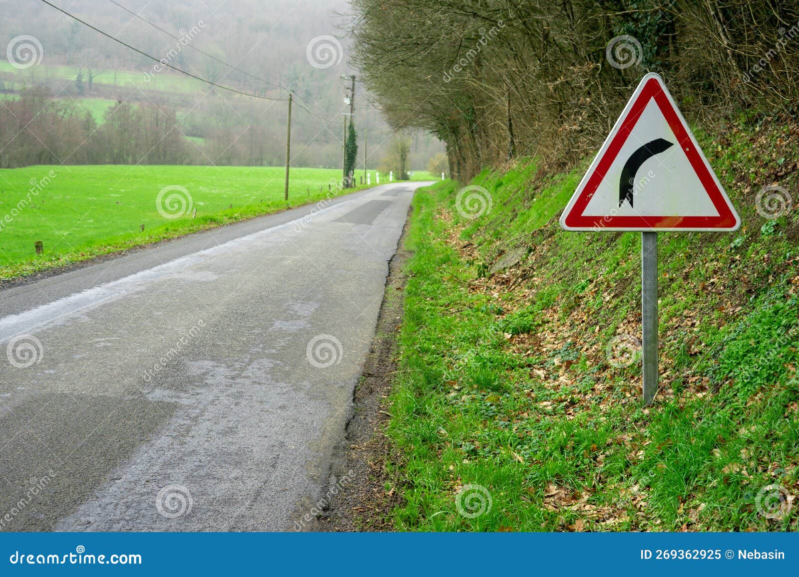 Road and Road Sign Warning about a Turn in the Road. Road Safety ...