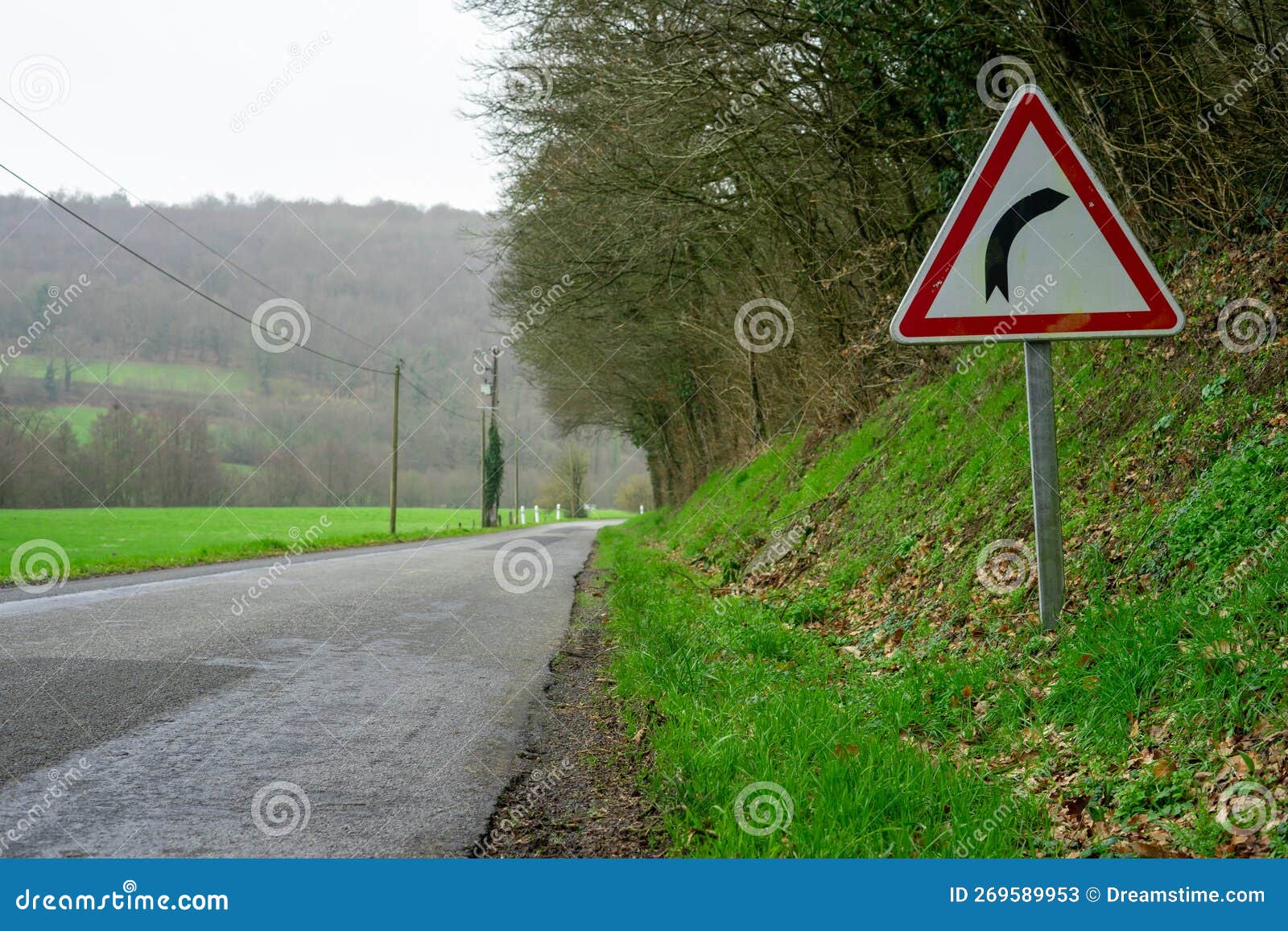Road and Road Sign Warning about a Turn in the Road. Road Safety ...