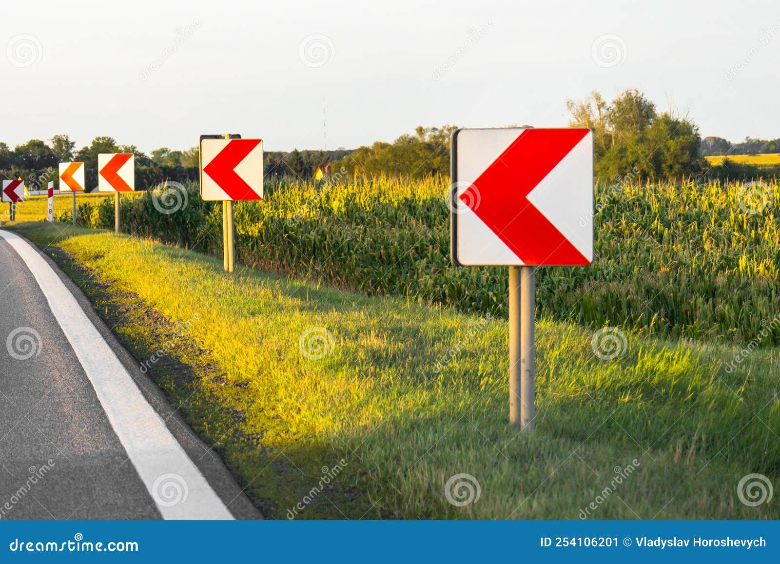 Road Signs in European Style Warn of a Sharp Turn on a Narrow Road, a ...