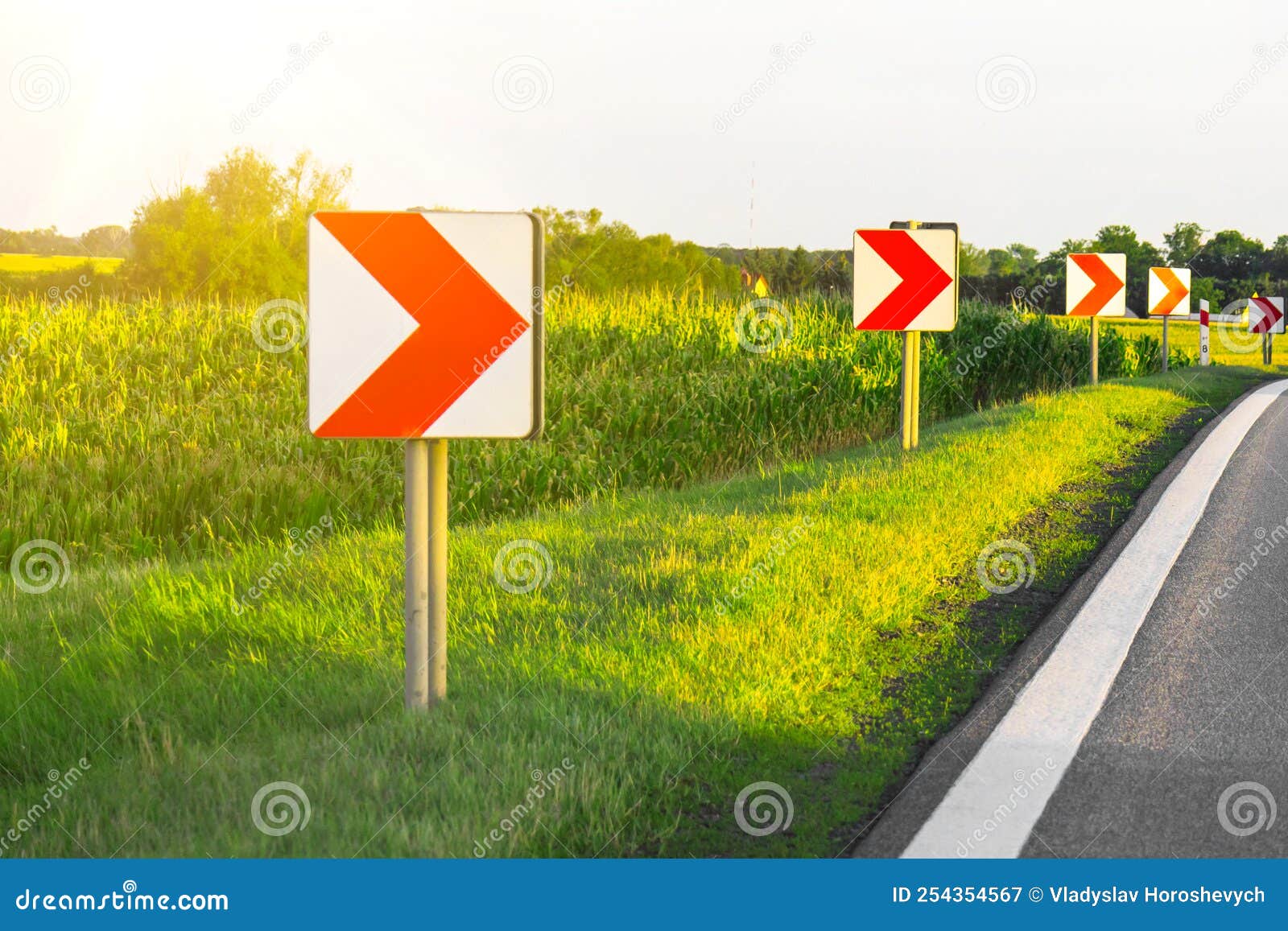 Road Signs in European Style Warn of a Sharp Turn on a Narrow Road, a ...