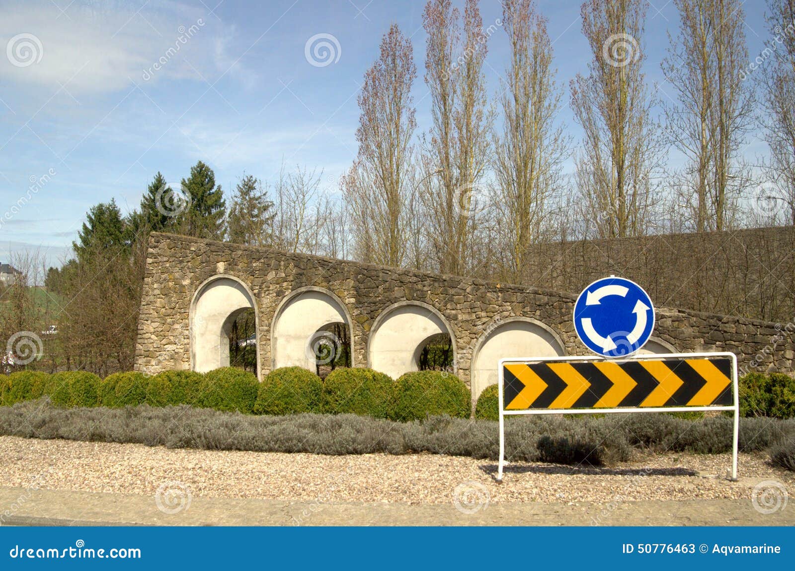 Road signs in stone wall stock image. Image of cities - 50776463