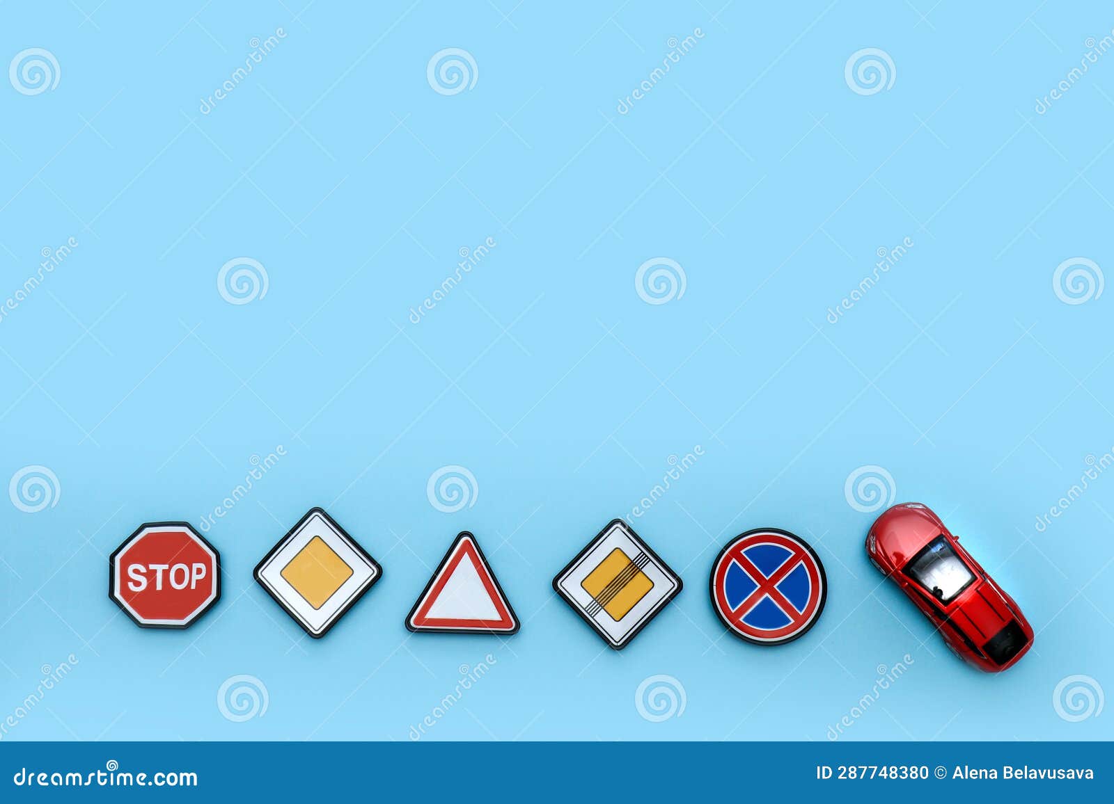 Road Signs and Toy Car on Blue Background with Copy Space Stock Photo ...