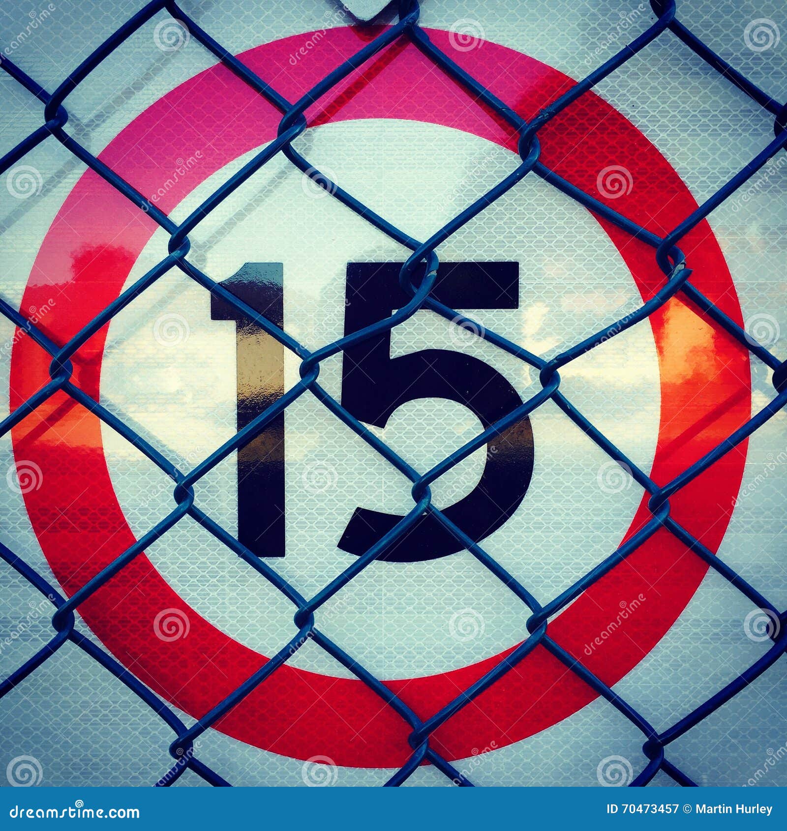 15 Road Speed Sign with Red Circle and Chain Link Fence Stock Image ...